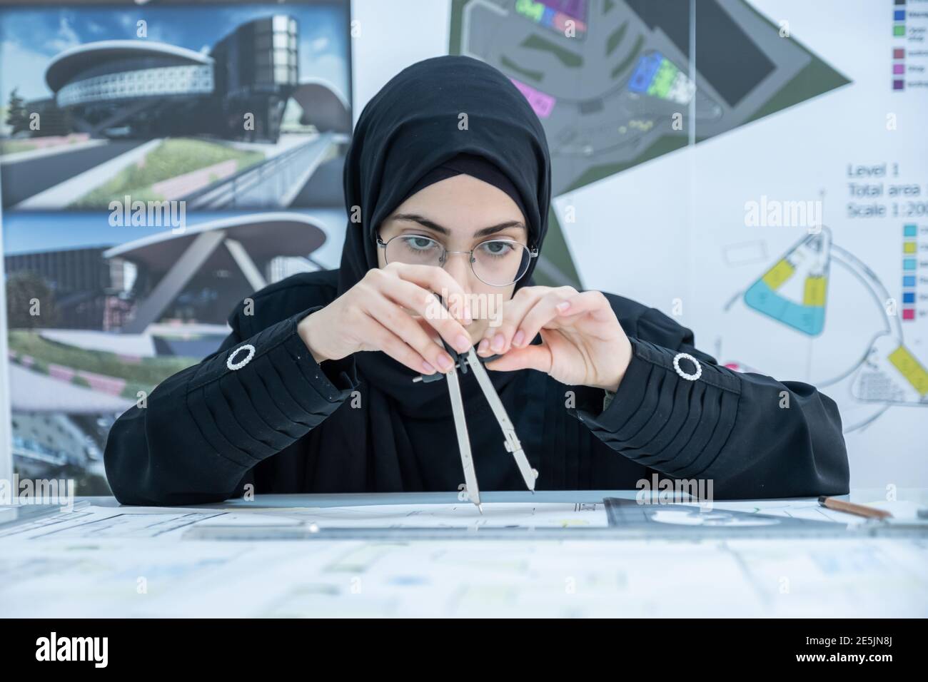 Female arab architect using compass Stock Photo - Alamy