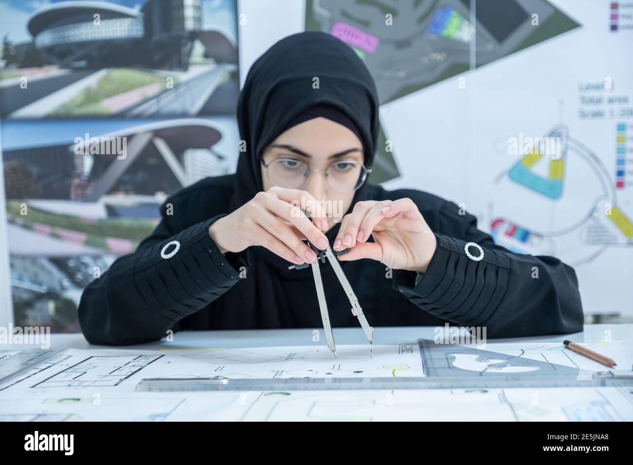 Female arab architect using compass Stock Photo - Alamy