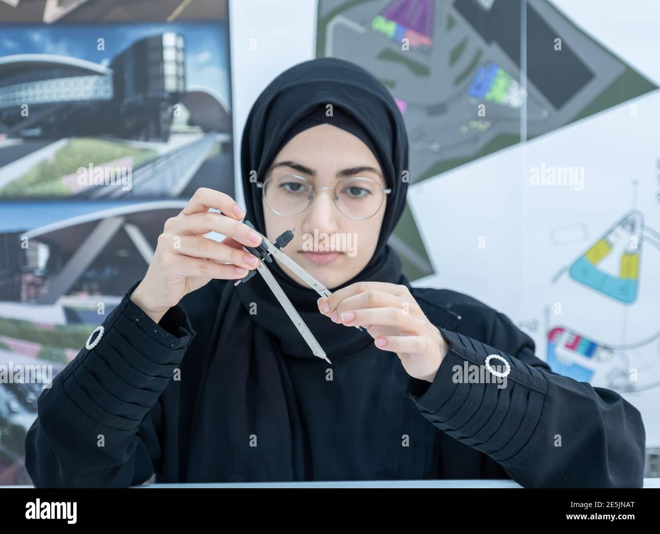 Female arab architect using compass Stock Photo - Alamy