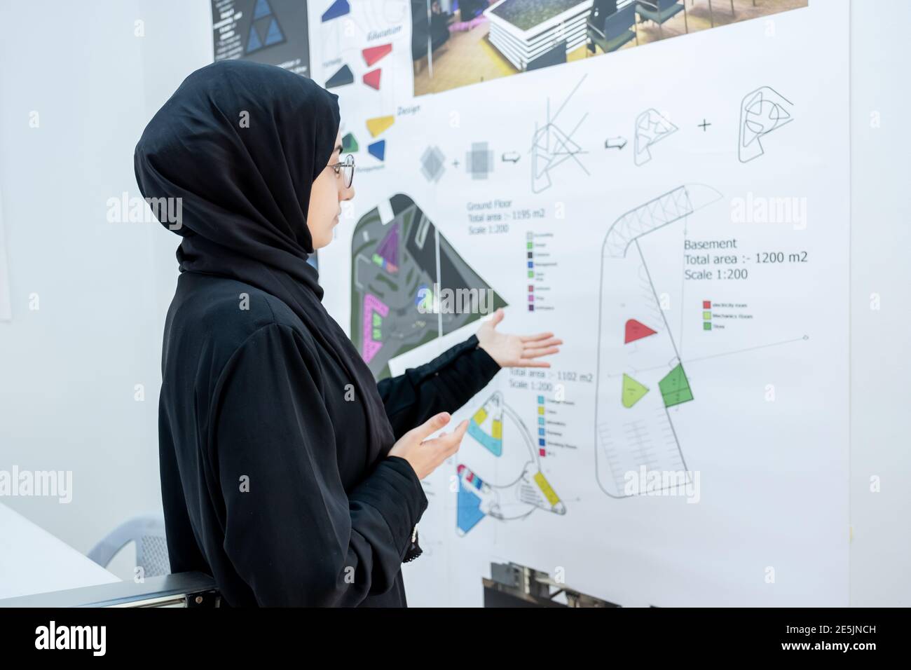 Arab female architect welcoming others to see her project Stock Photo ...