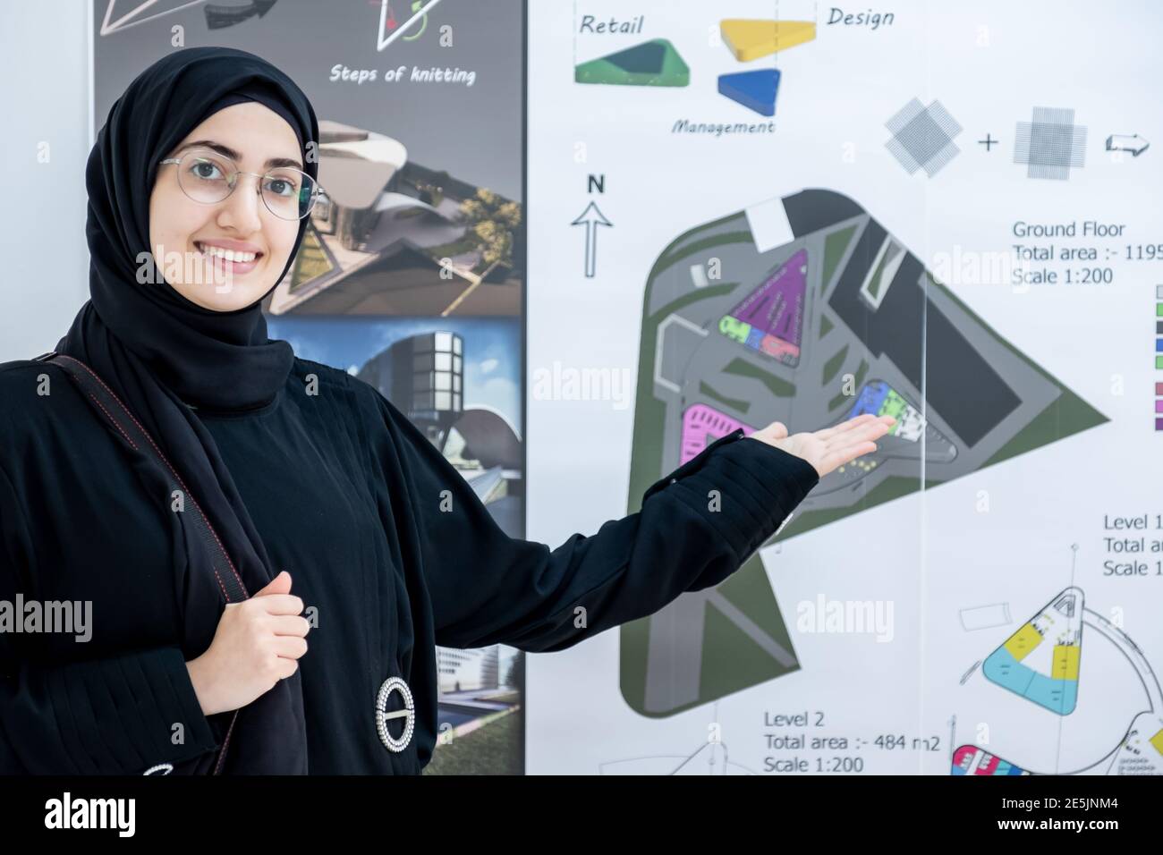 Arab female architect welcoming others to see her project Stock Photo ...