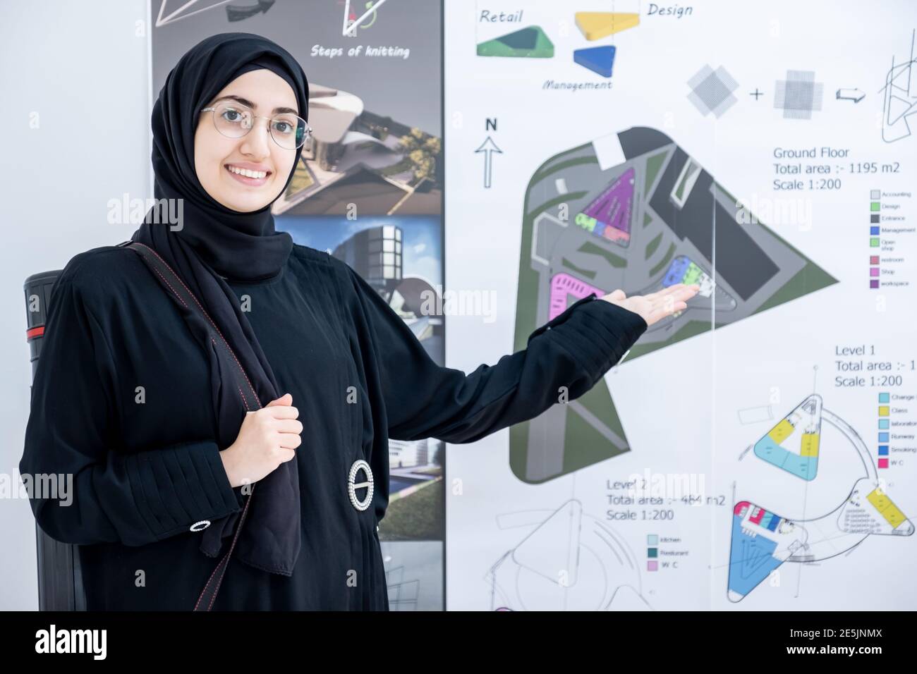Arab female architect welcoming others to see her project Stock Photo ...