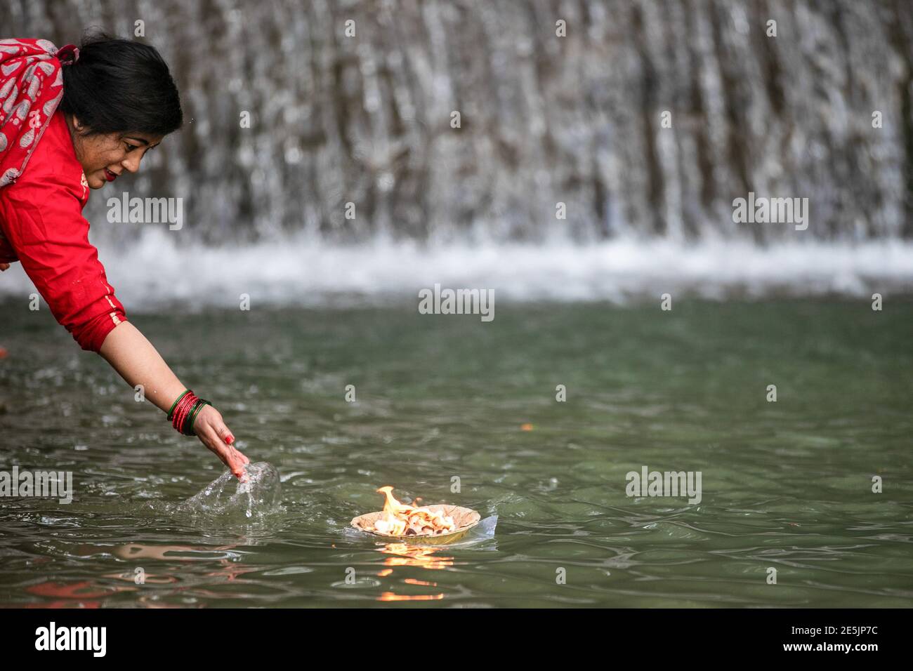 A Hindu devotee offers prayers at Shali River during the Swasthani ...