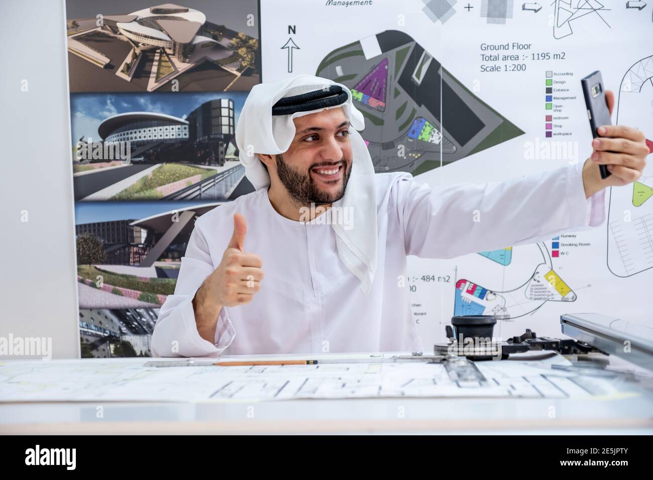 Arab male architect show hie thump up and having an online call Stock ...