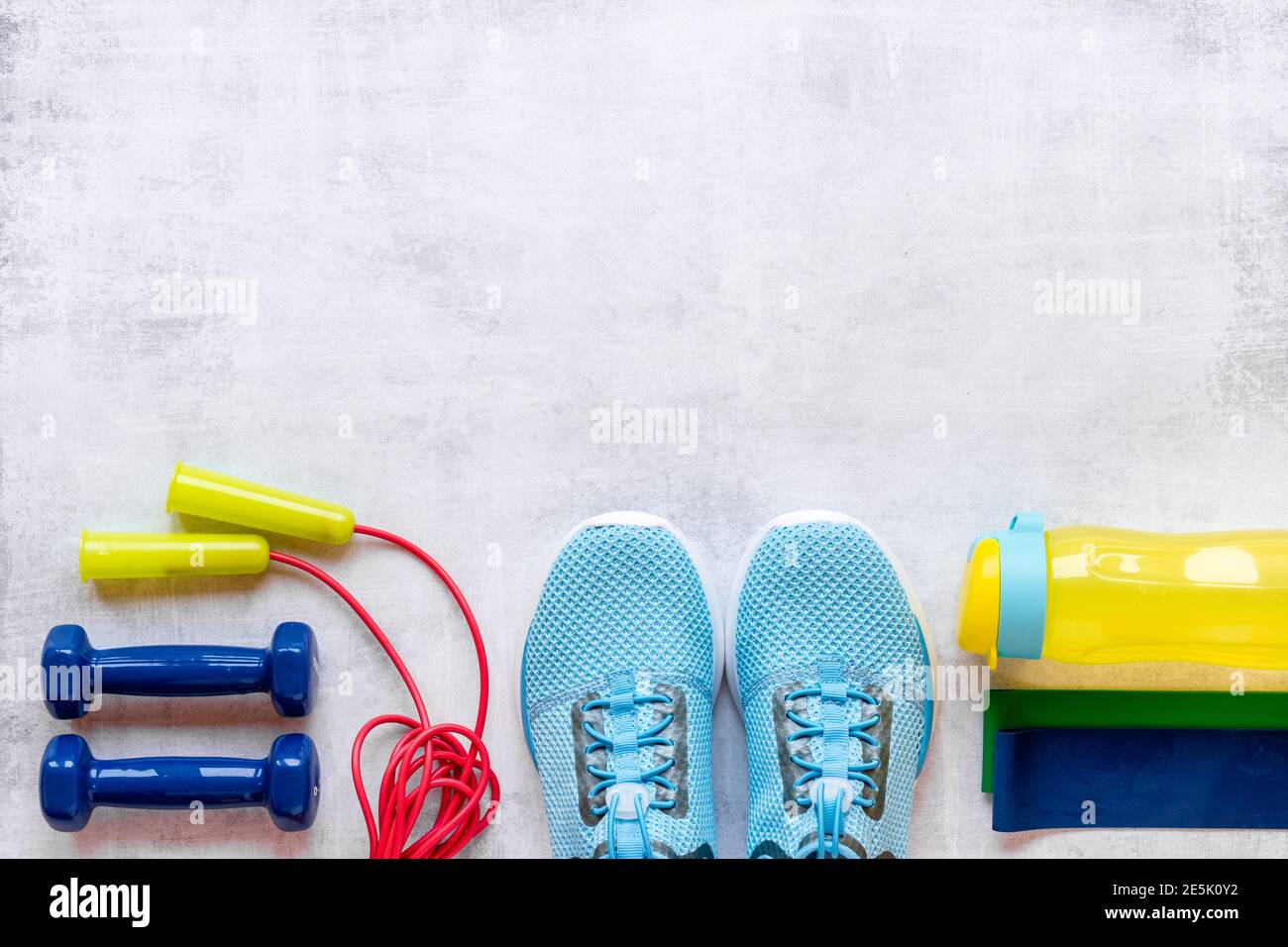 Athlete set of sneakers and bottle of water on bright blue background ...