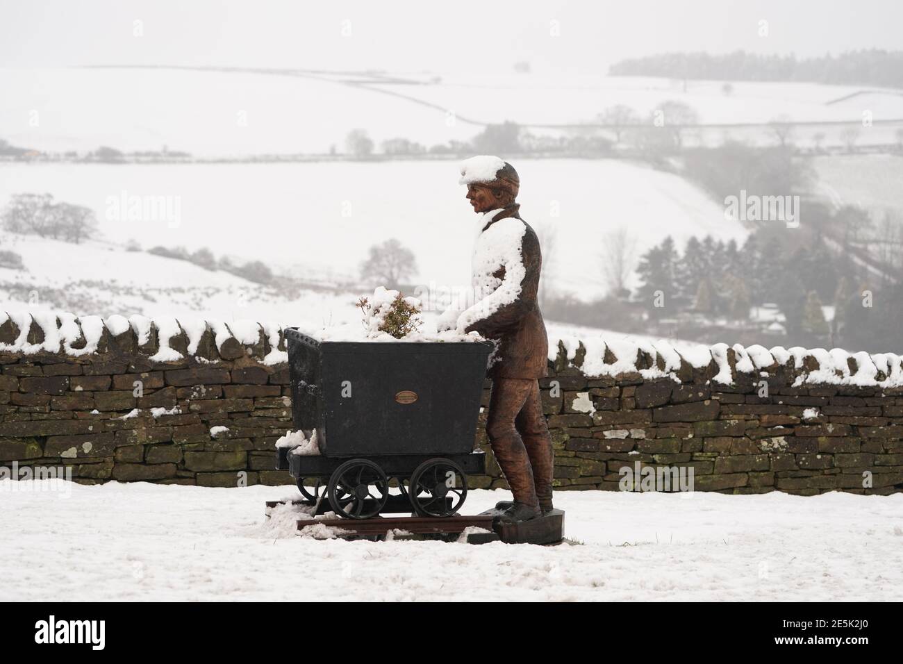 A sculpture of a lead miner covered in snow at Rowley Bank (the A68 ...
