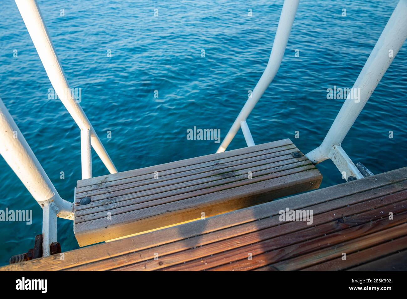 Old wood stairs on a pier and a beautiful water Stock Photo - Alamy