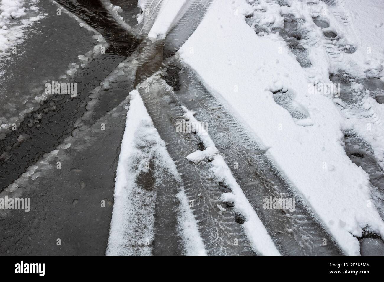 Tire tracks and footprints in snowy road hi-res stock photography and ...