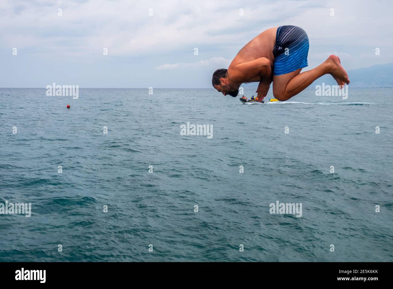 Man jumping inside the ocean Stock Photo - Alamy