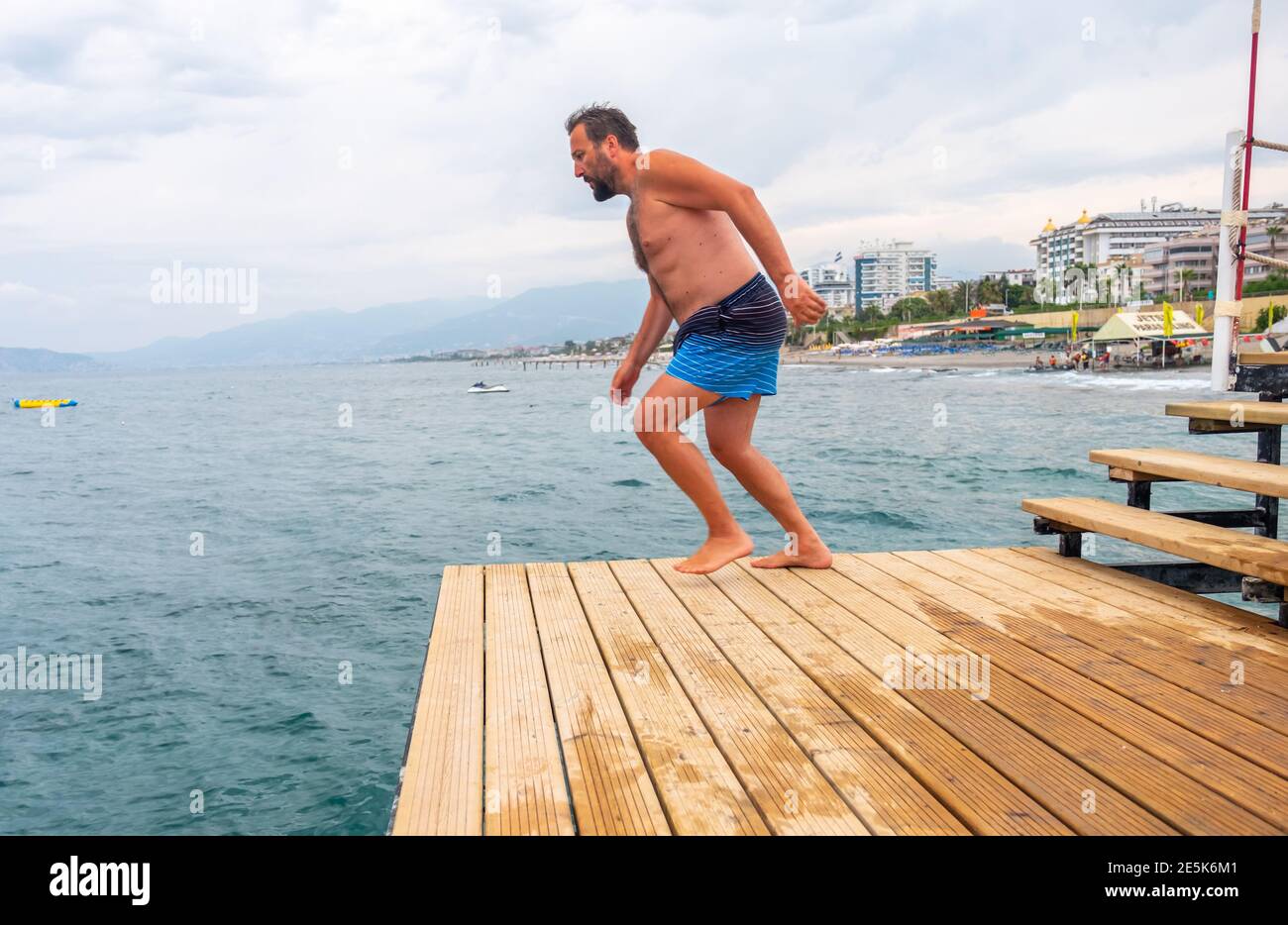Man jumping inside the ocean Stock Photo - Alamy