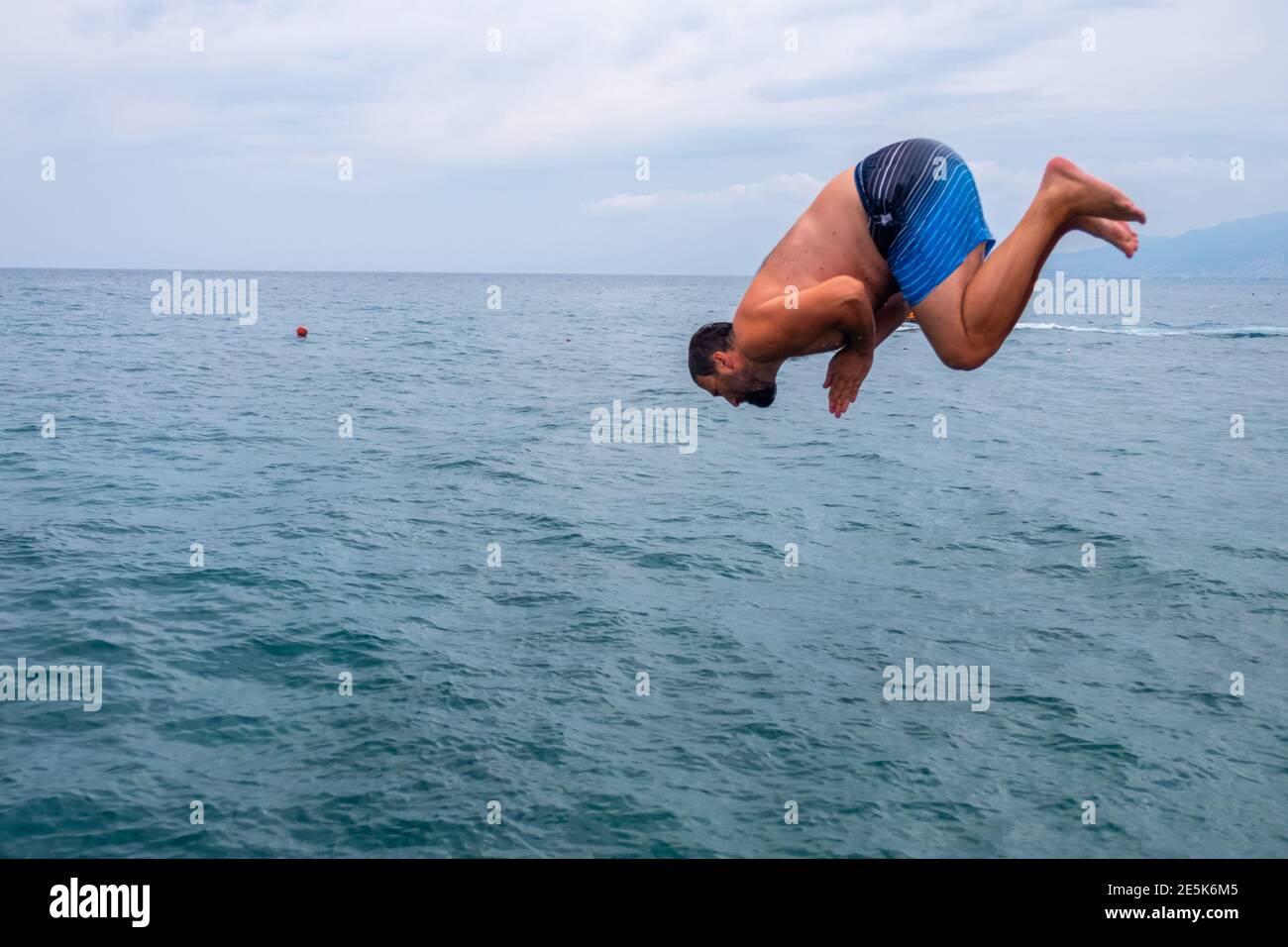 Man jumping inside the ocean Stock Photo - Alamy