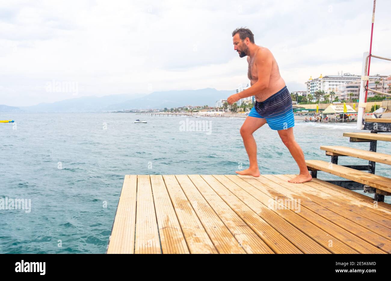 Man jumping inside the ocean Stock Photo - Alamy
