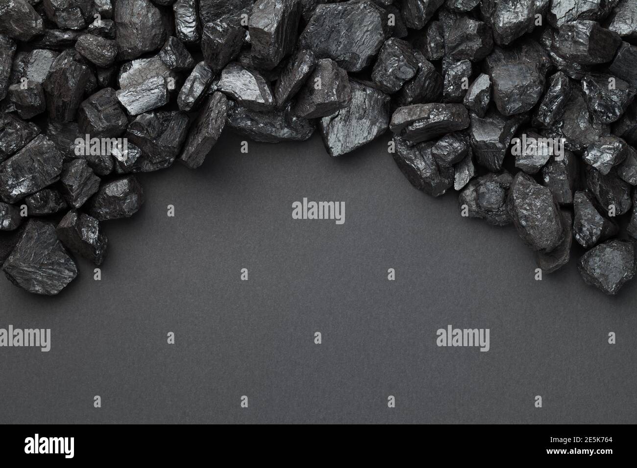 Black coal border over dark background. Empty room for text. Top view ...
