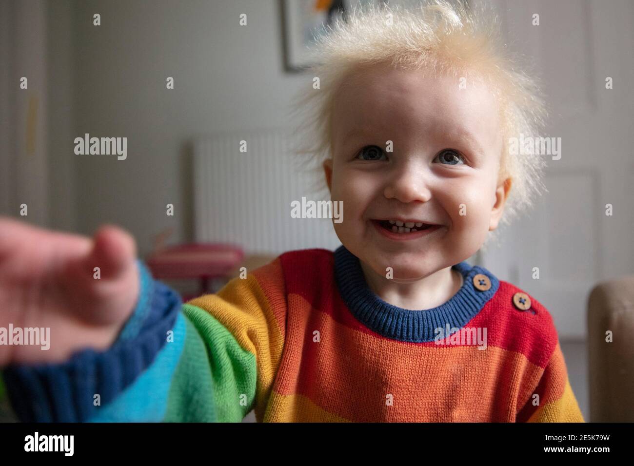 Portrait of a happy young boy reaching out towards the camera Stock ...