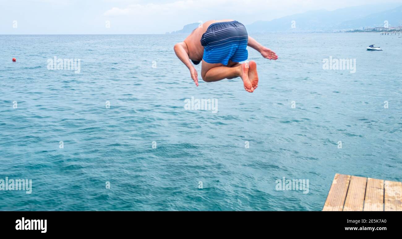 Man jumping inside the ocean Stock Photo - Alamy