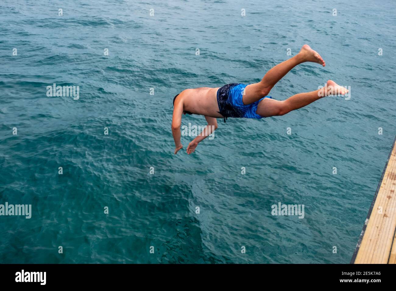 Man jumping inside the ocean Stock Photo - Alamy