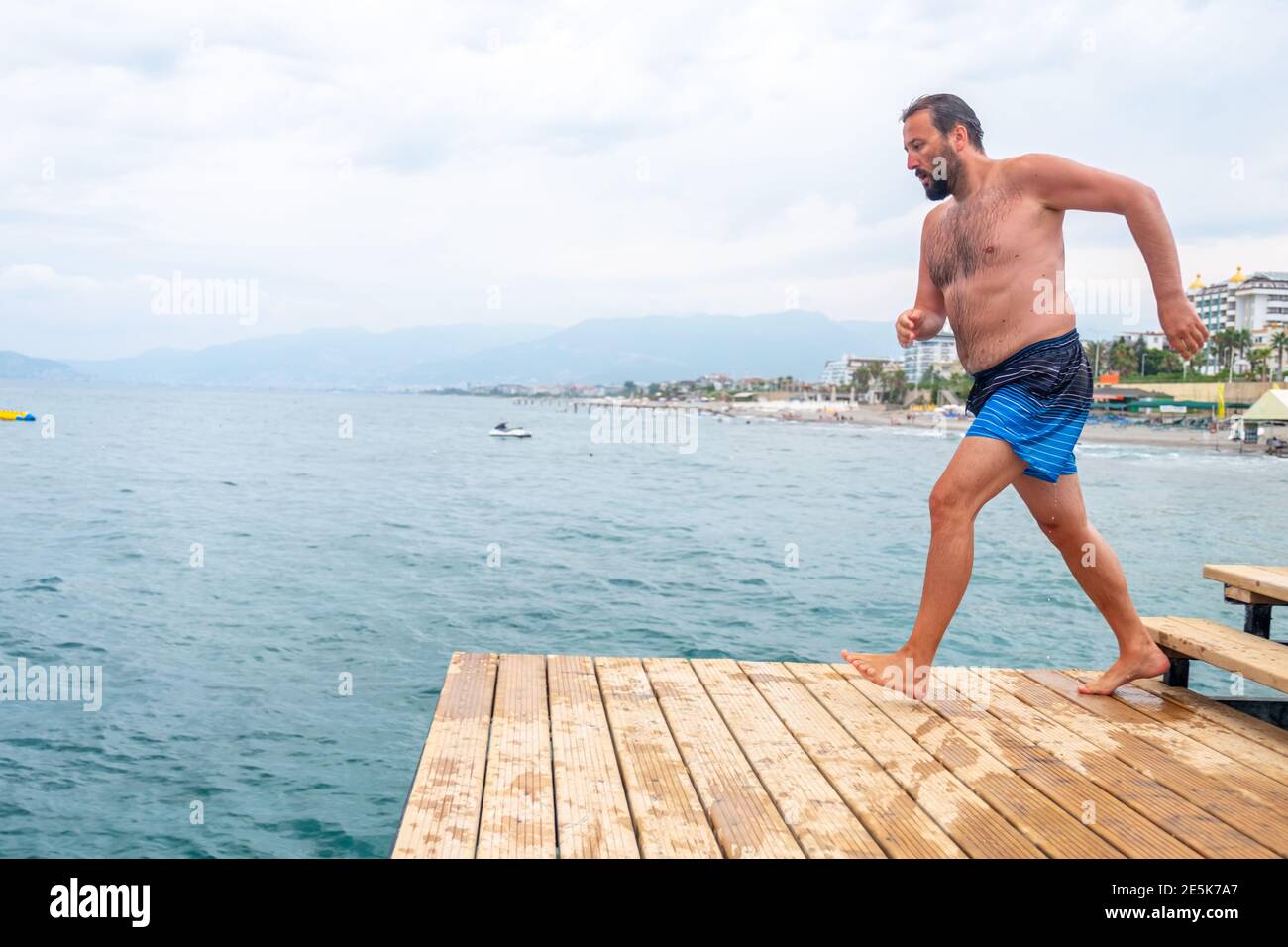 Man jumping inside the ocean Stock Photo - Alamy
