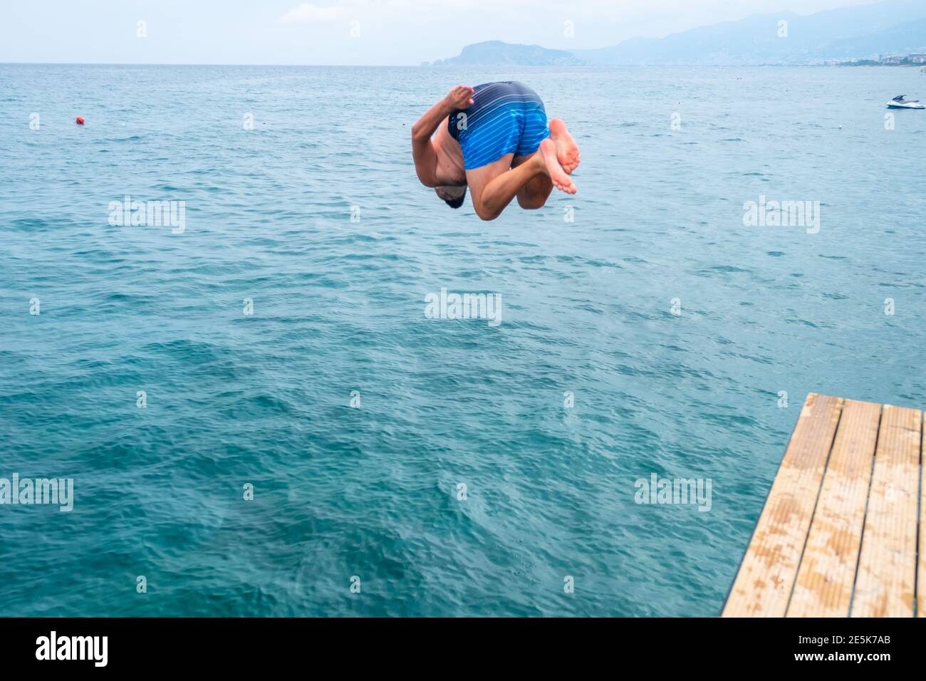 Man jumping inside the ocean Stock Photo - Alamy