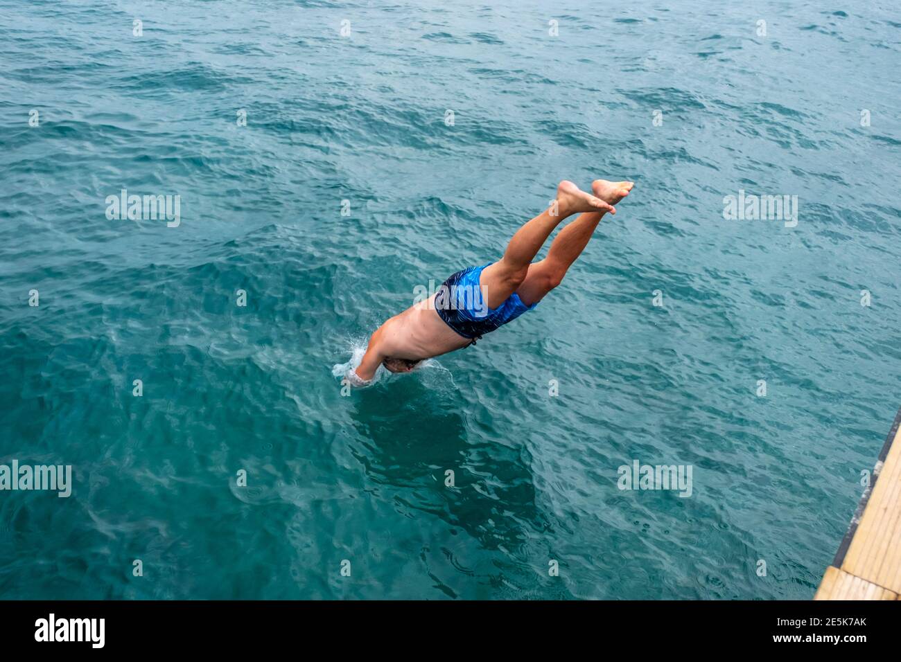 Man jumping inside the ocean Stock Photo - Alamy