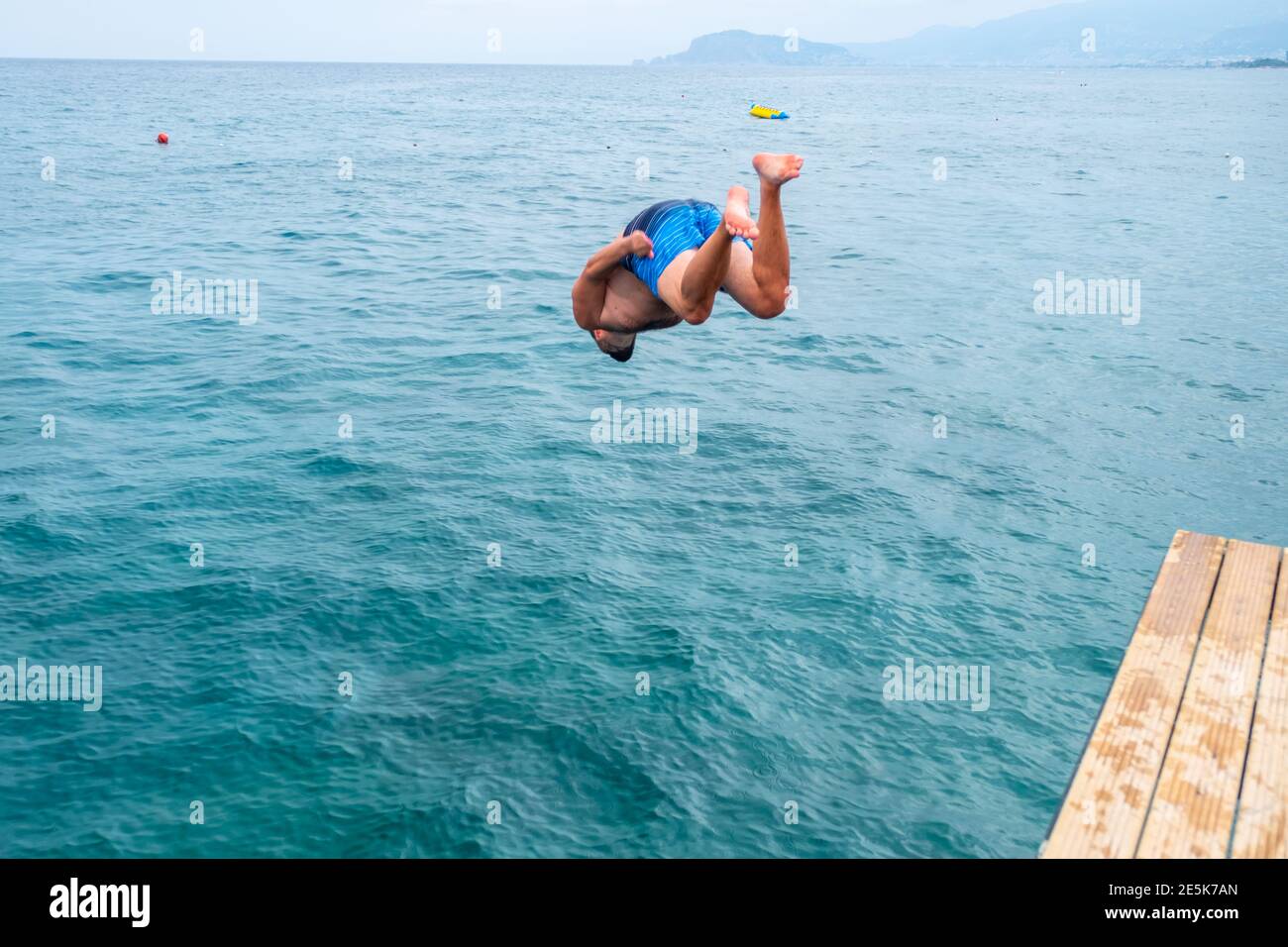 Man jumping inside the ocean Stock Photo - Alamy
