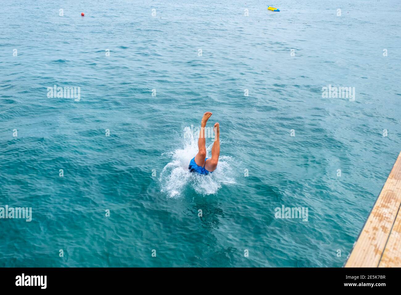 Man jumping inside the ocean Stock Photo - Alamy