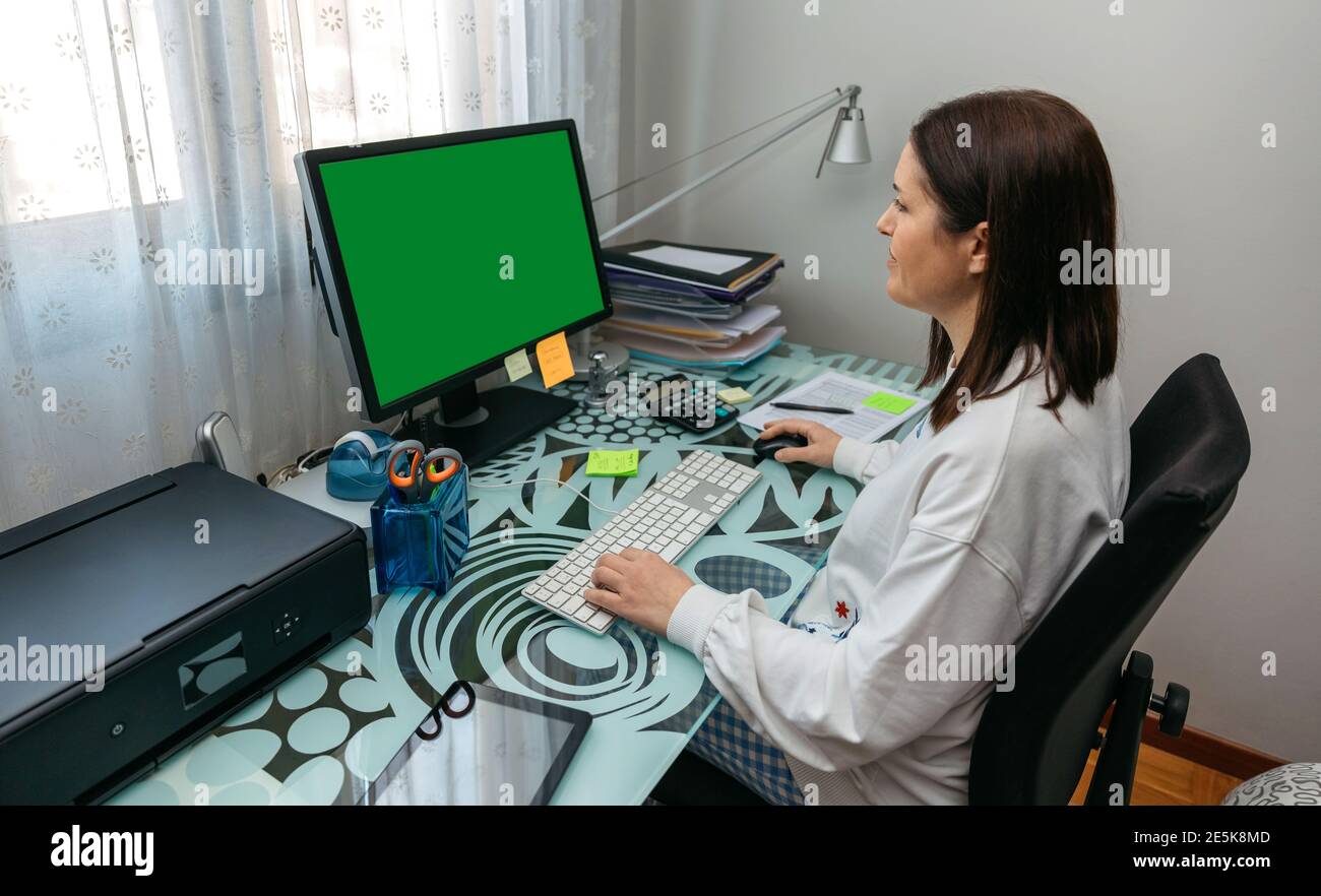 Woman looking at computer screen Stock Photo - Alamy