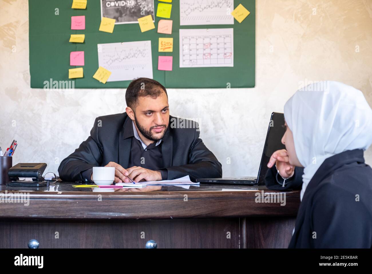 Job interview between man and muslim woman wearing hijab in the office ...