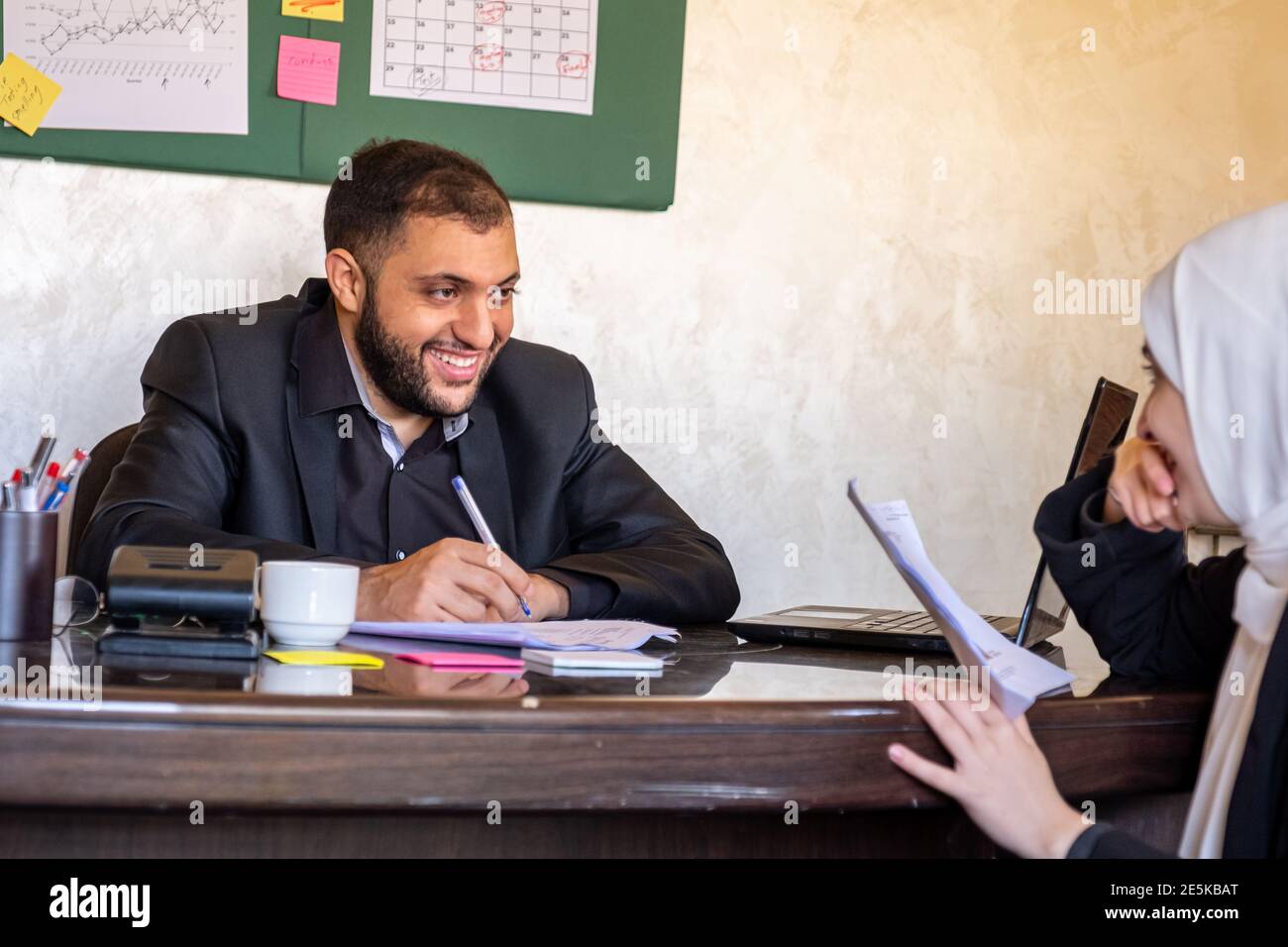 Job interview between man and muslim woman wearing hijab in the office ...