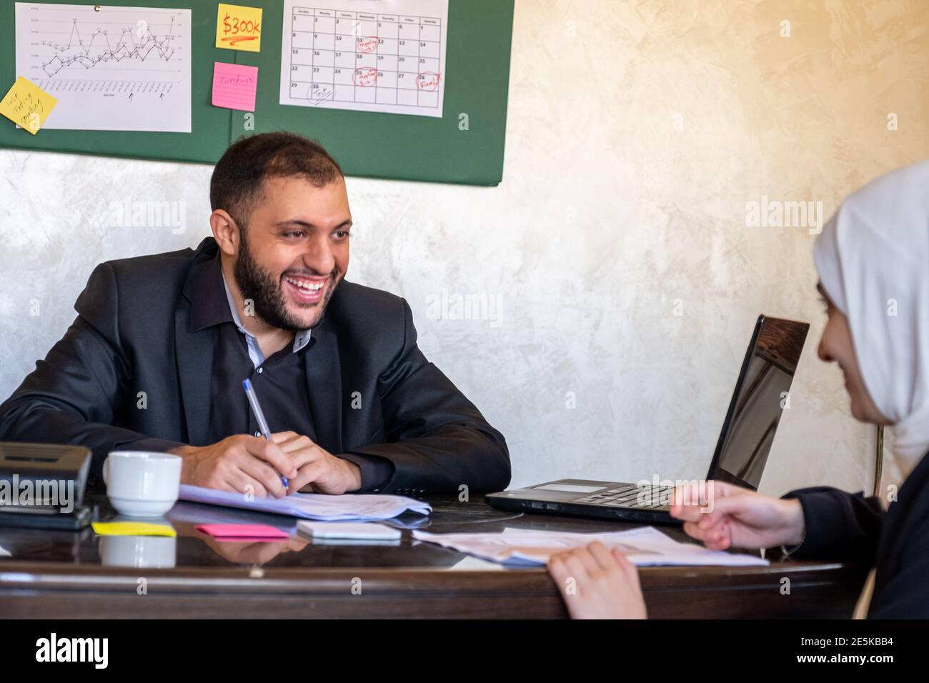 Job interview between man and muslim woman wearing hijab in the office ...