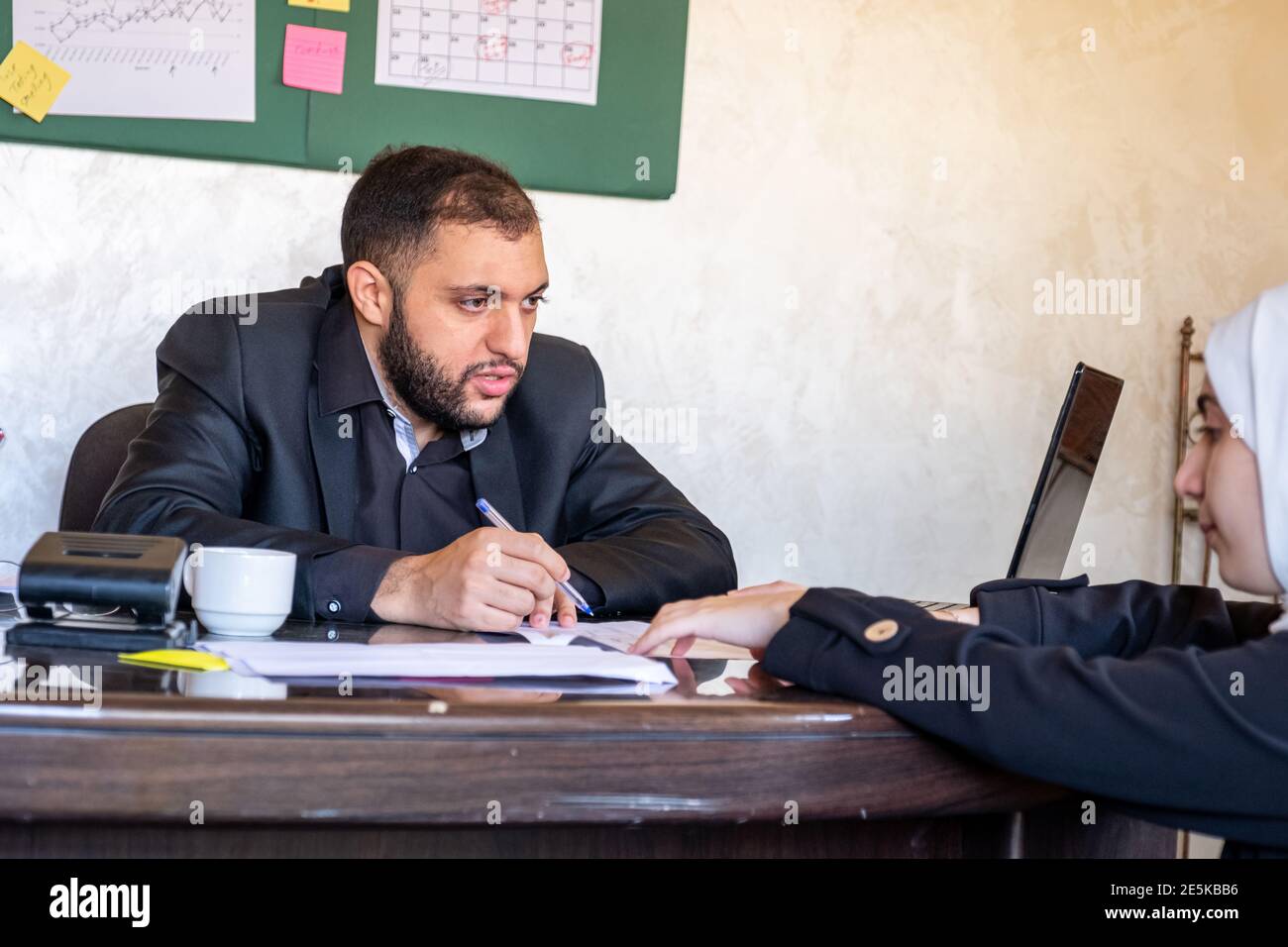 Job interview between man and muslim woman wearing hijab in the office ...