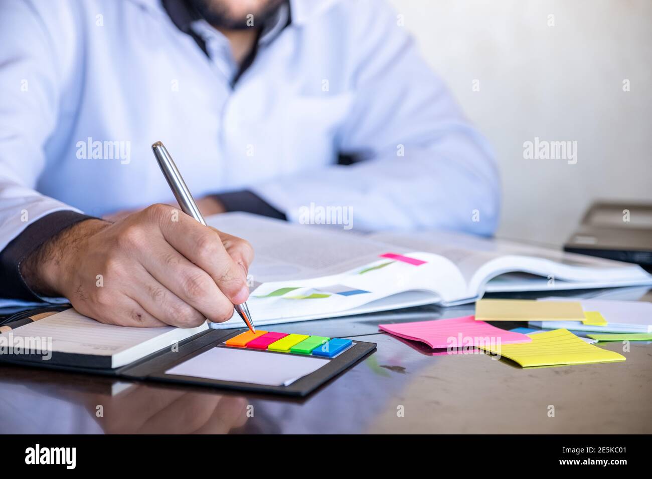Male doctor hands writing a note Stock Photo - Alamy