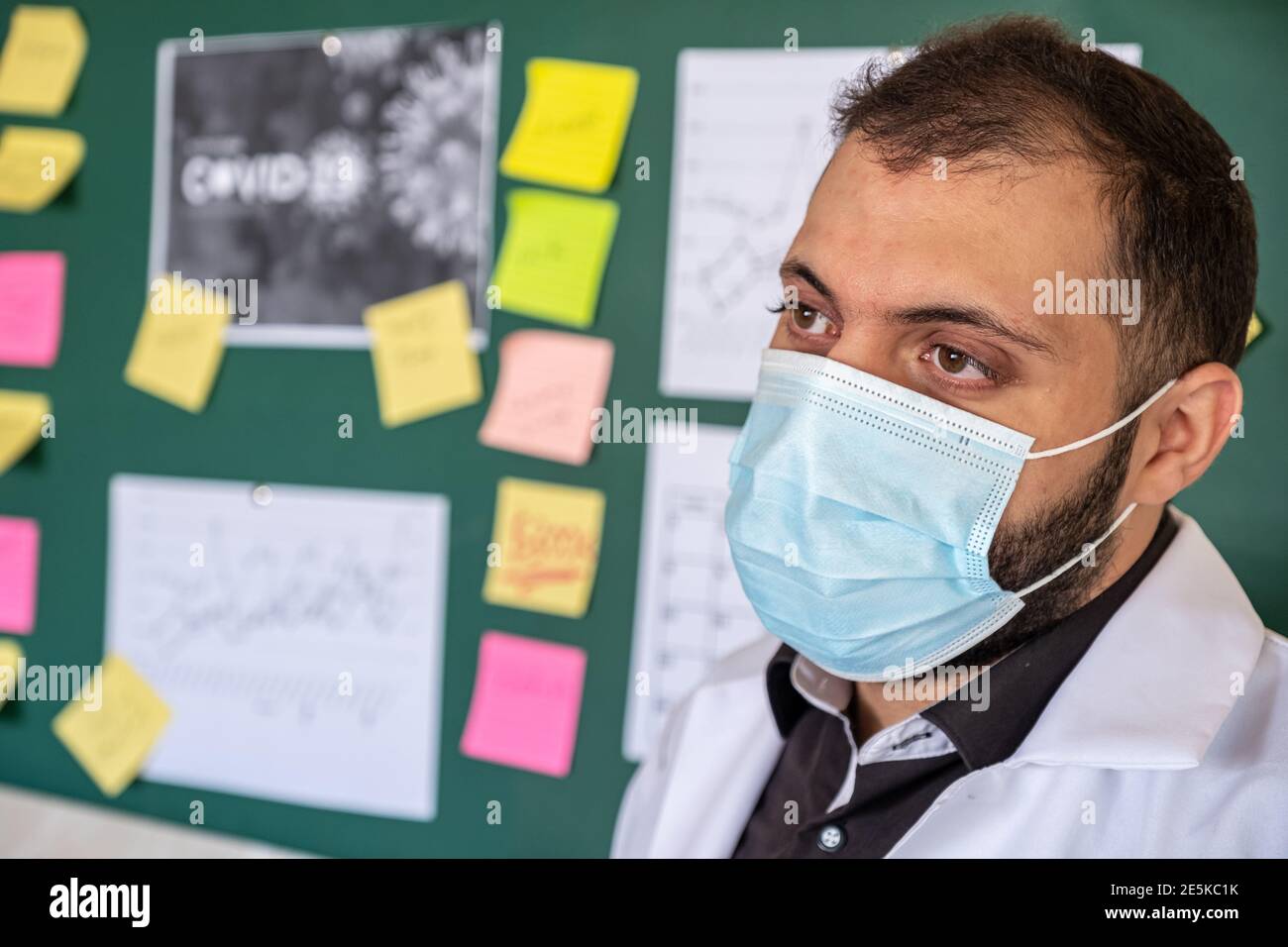 Male doctor wearing his mask Stock Photo - Alamy