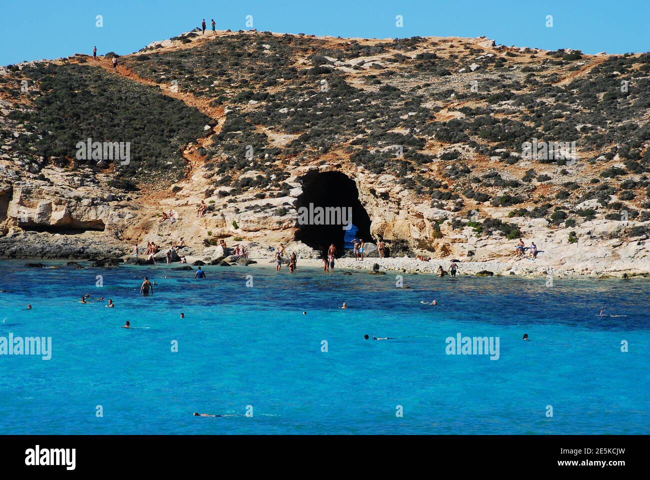 The cave in Cominotto Maltese island with azure Comino Blue Lagoon ...