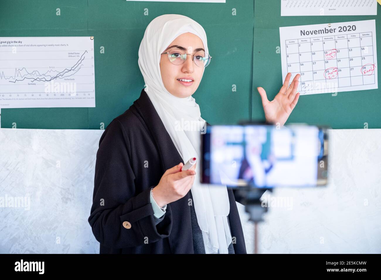 Happy muslim woman coach teacher webinar speaker looking at camera ...