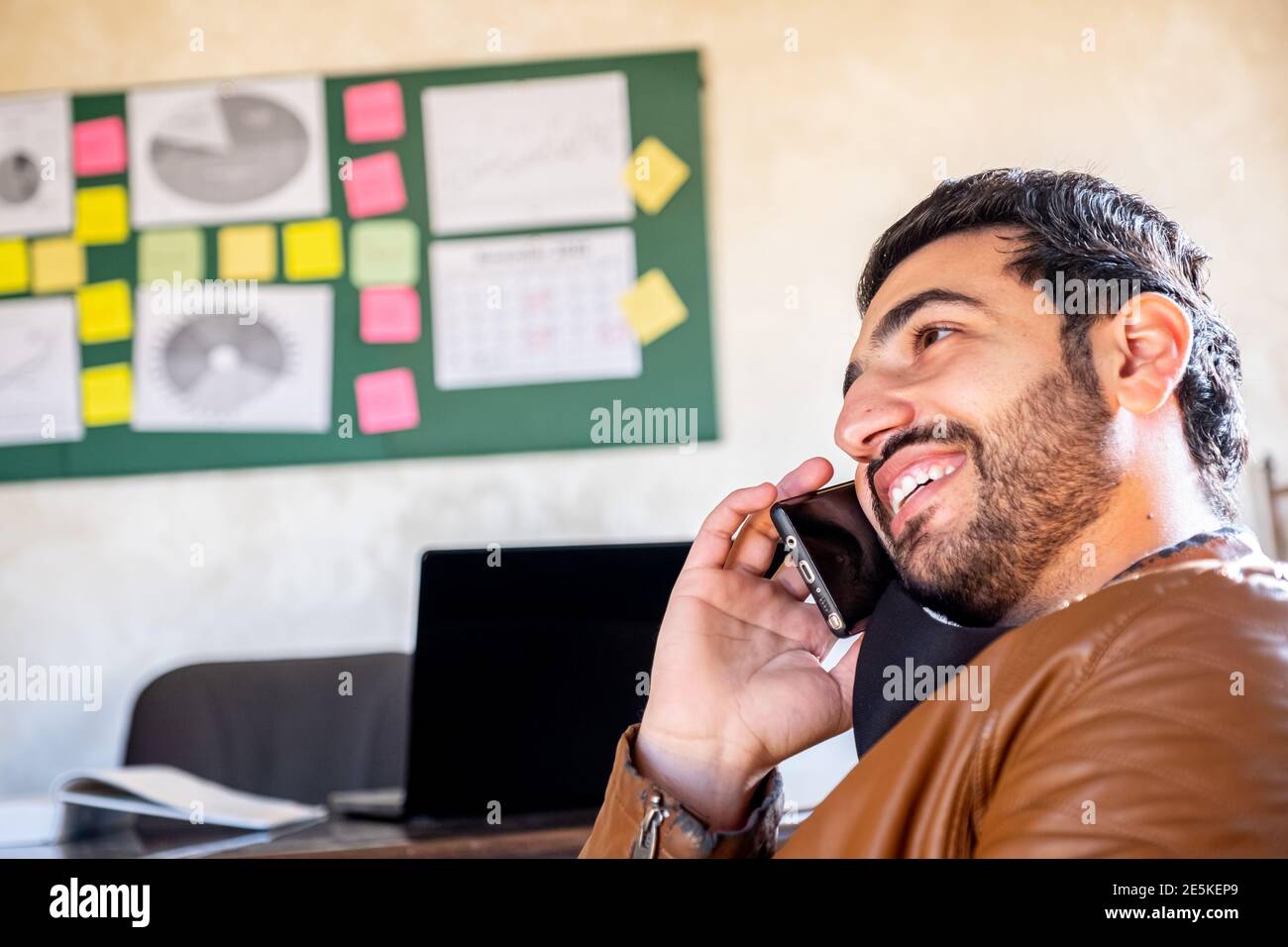 man using his contacting through his phone while waiting the assistance ...
