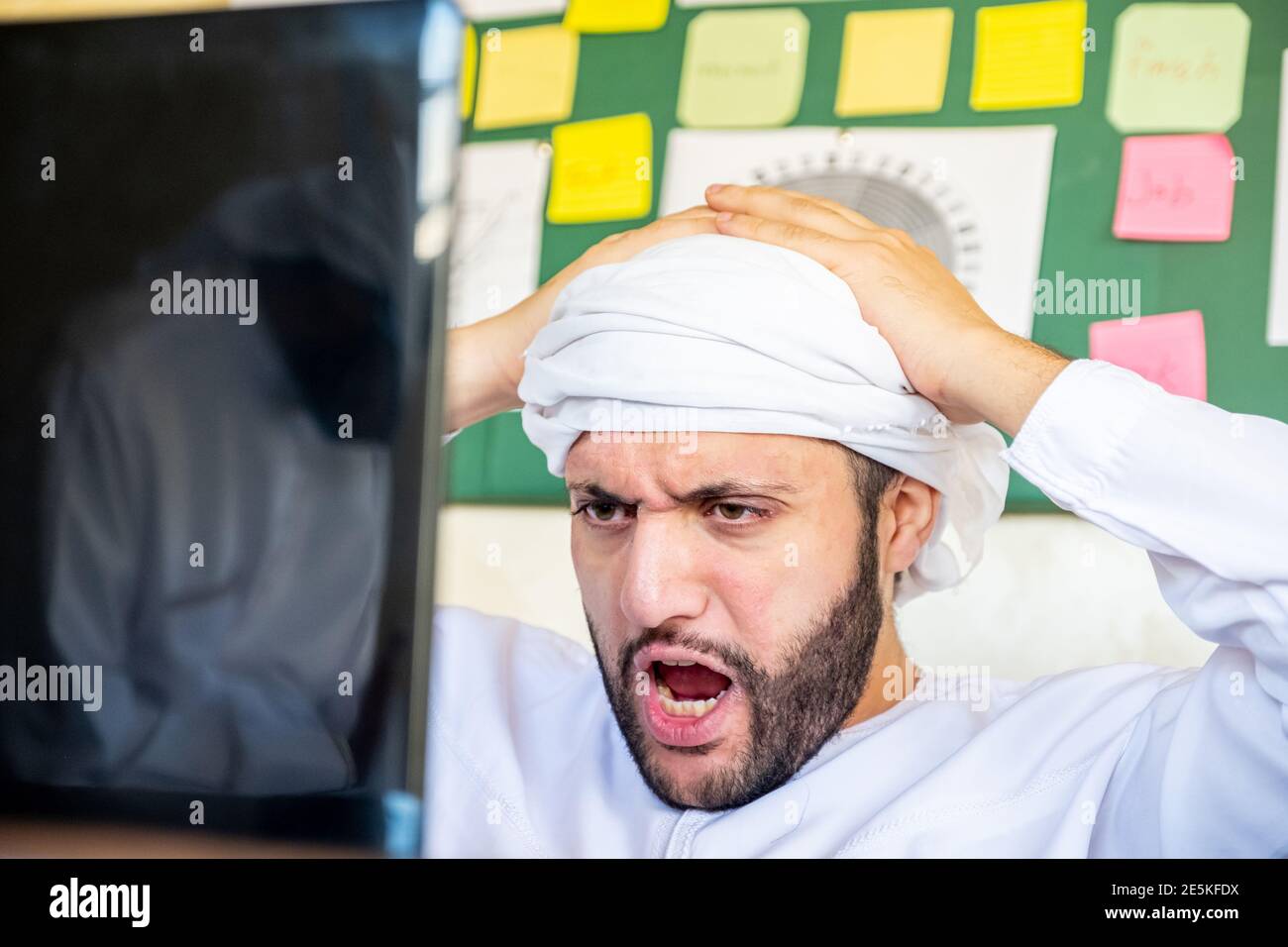 Young Arabian man have bad results with a terrified look and anger on ...
