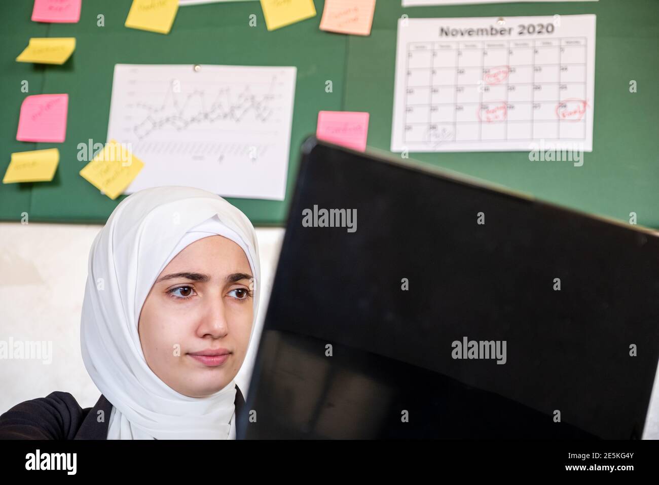 Muslim women working in the office from home using laptop Stock Photo ...