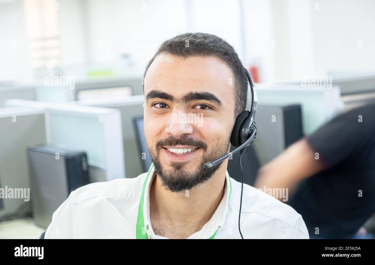 Cheerful call center agent with beautiful gesture Stock Photo - Alamy
