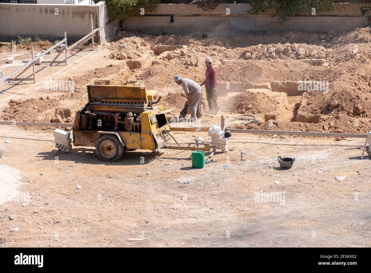 Workers are digging up the foundations for a new house according to the ...