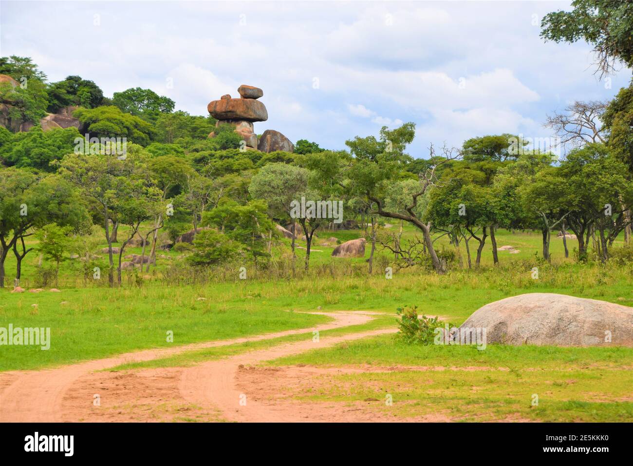 African landscape with a dirt road and natural balancing rocks ...