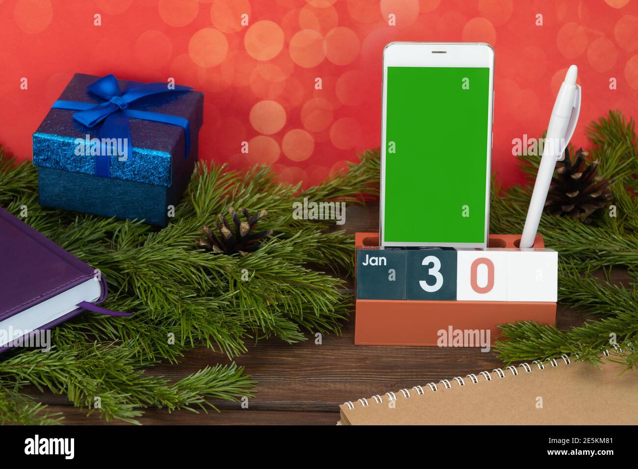 desktop calendar with the date January 30 and a cell phone. Layout for ...