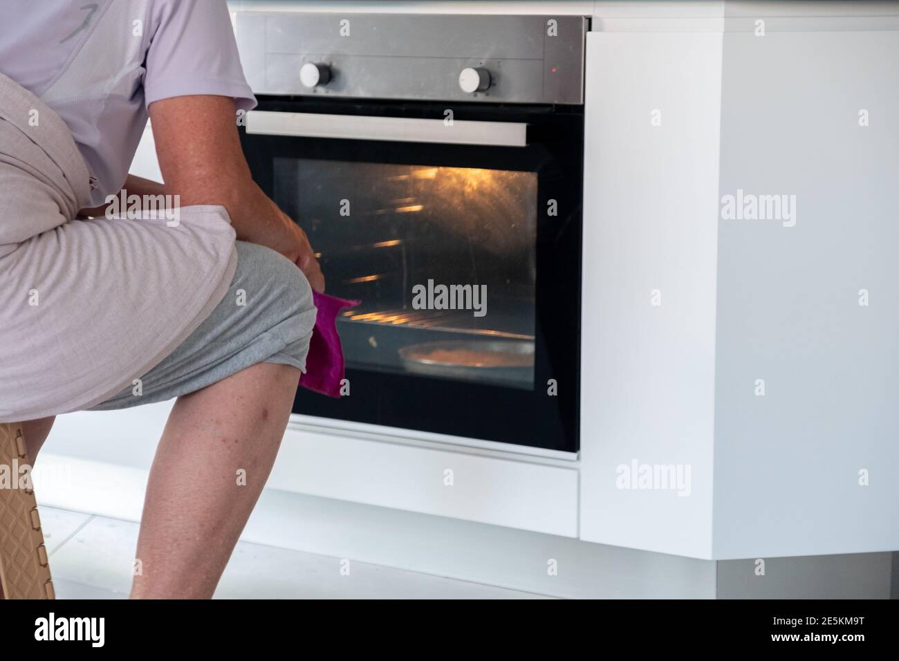 Old woman by electric fire hi-res stock photography and images - Alamy