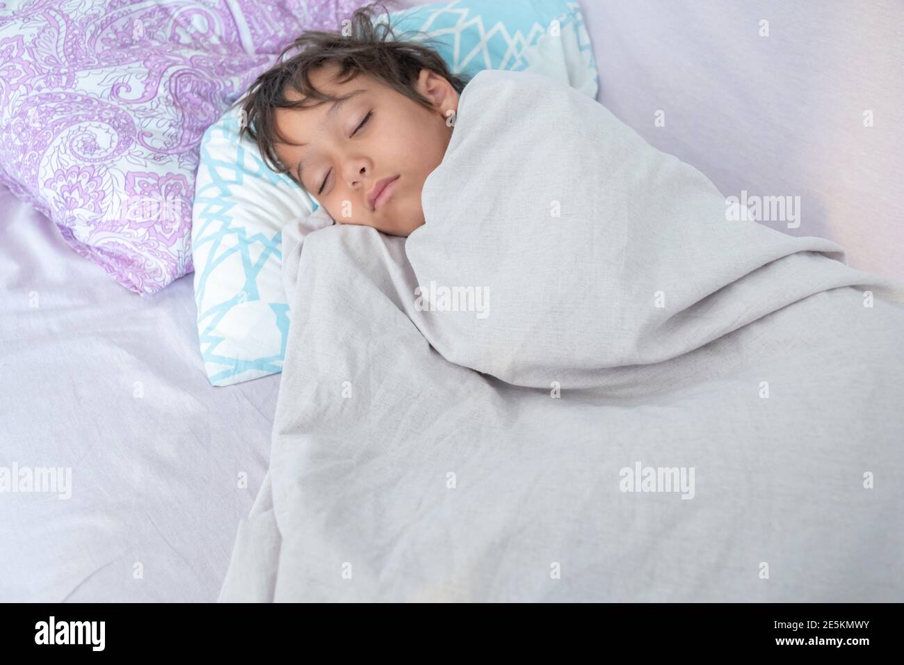 Cute boy sleeping on a white sofa with beautiful calm look on his face ...