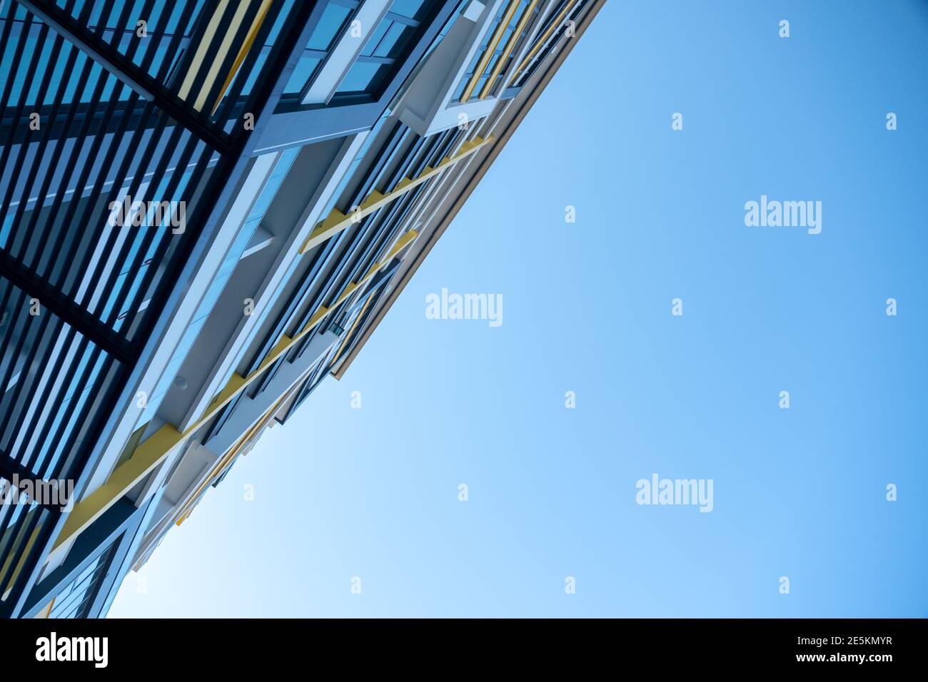 Urban Geometry, looking up to blue and Yellow building Modern ...