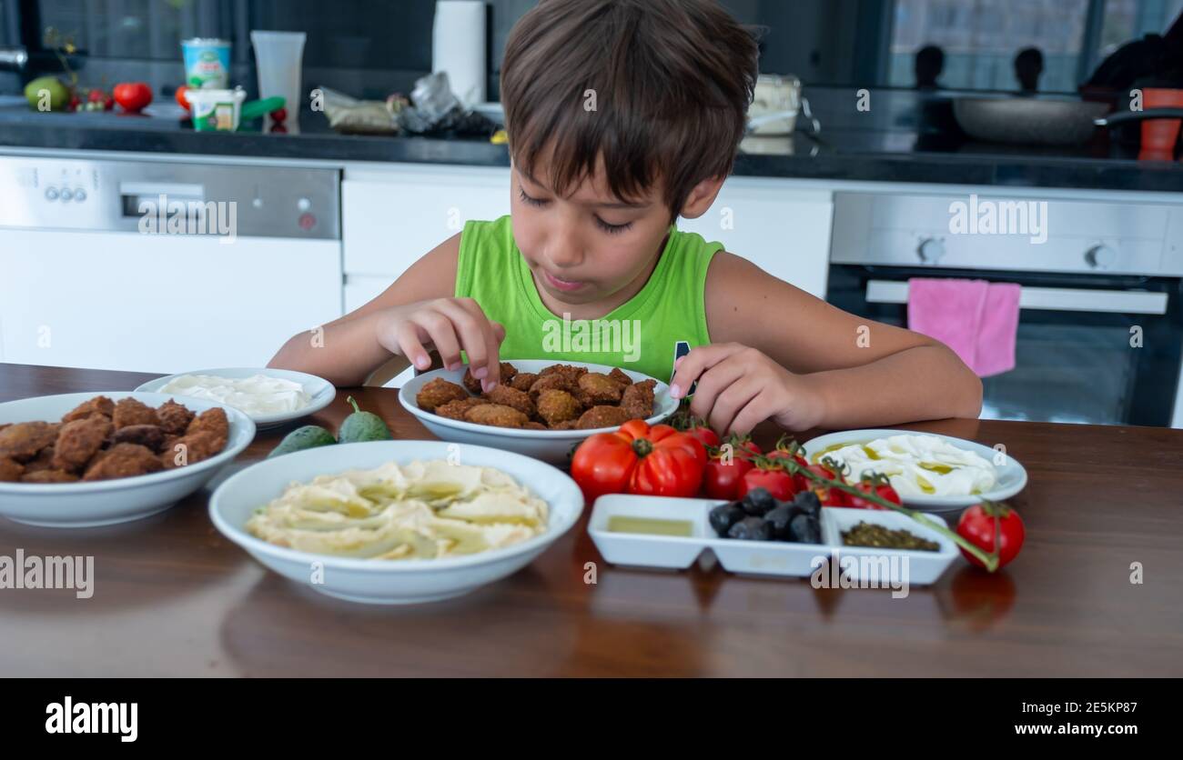 Boy is eating his breakfast Stock Photo - Alamy