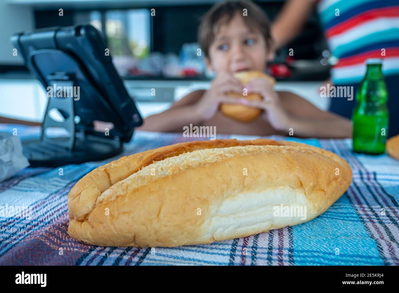 Boy is eating sandwitch and watching a movie Stock Photo - Alamy