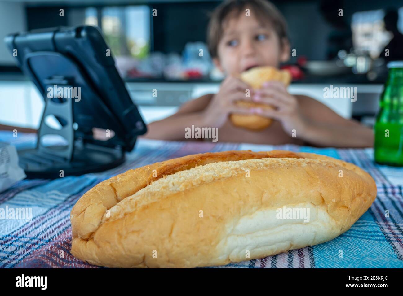 Boy is eating sandwitch and watching a movie Stock Photo - Alamy