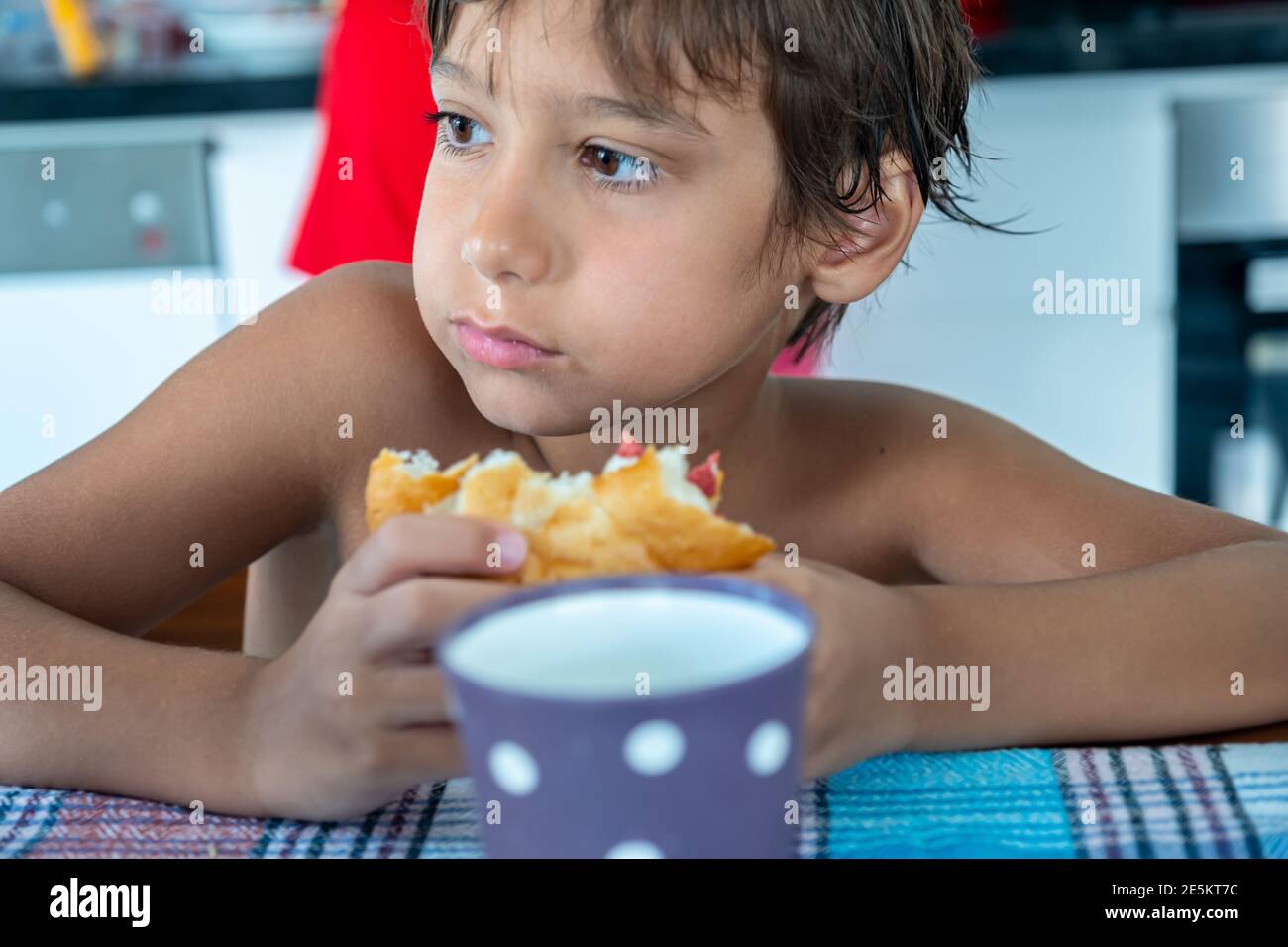 Boy is eating sandwitch and watching a movie Stock Photo - Alamy