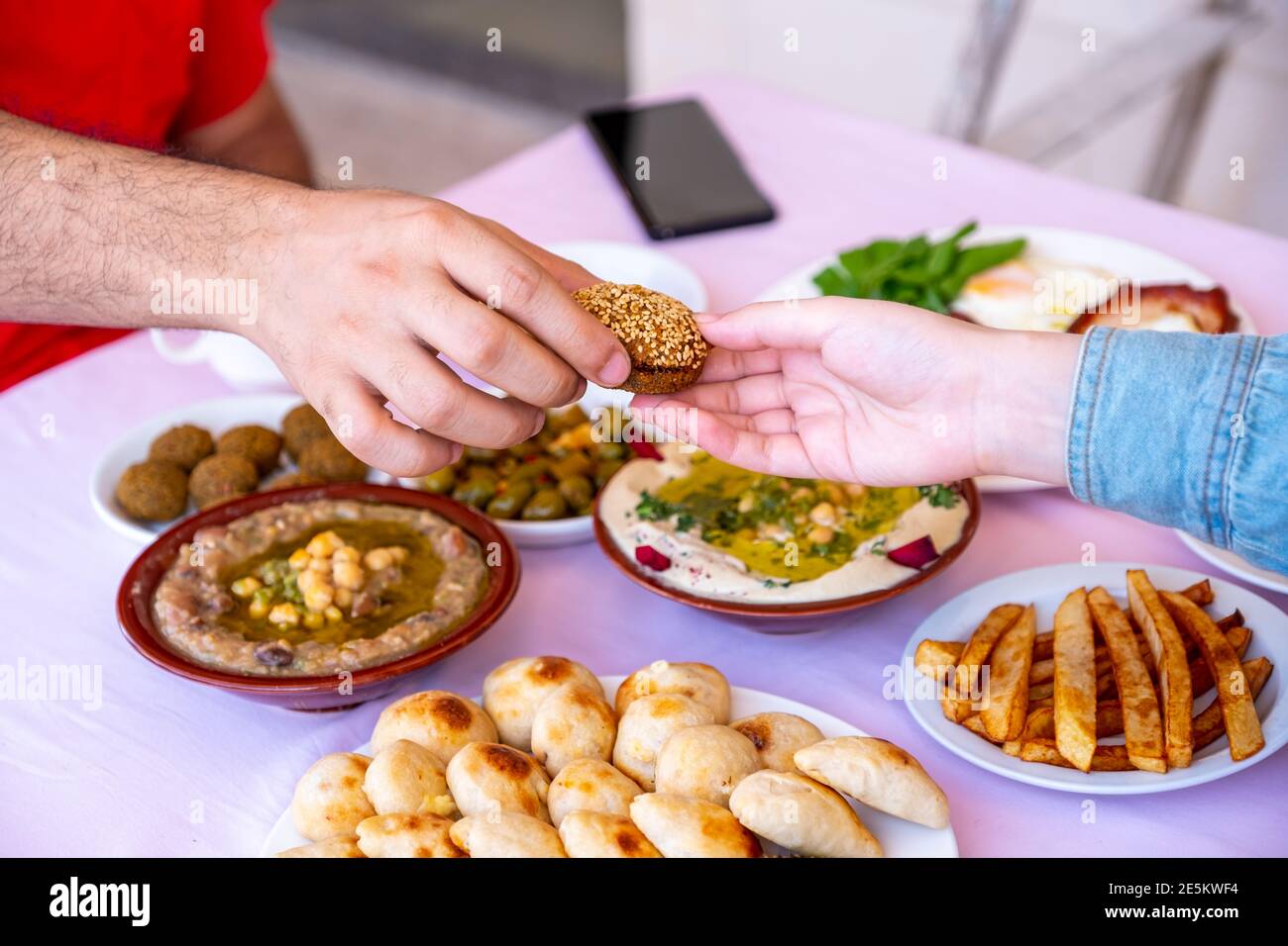 Eating breakfast together and having falafel is important Stock Photo ...
