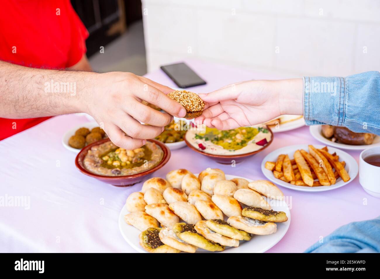 Eating breakfast together and having falafel is important Stock Photo ...